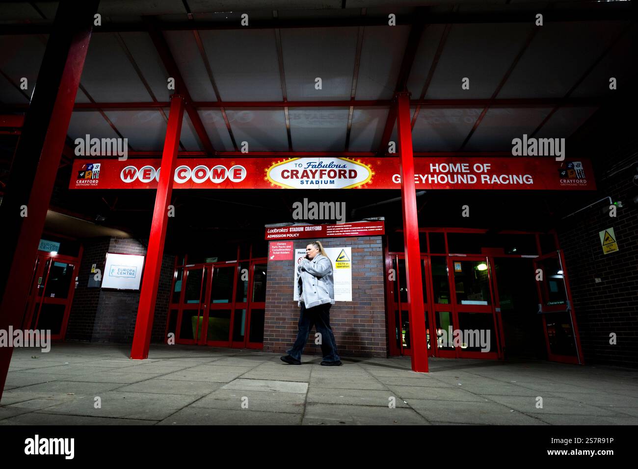 A spectator leaves the stadium after the final night of racing at ...