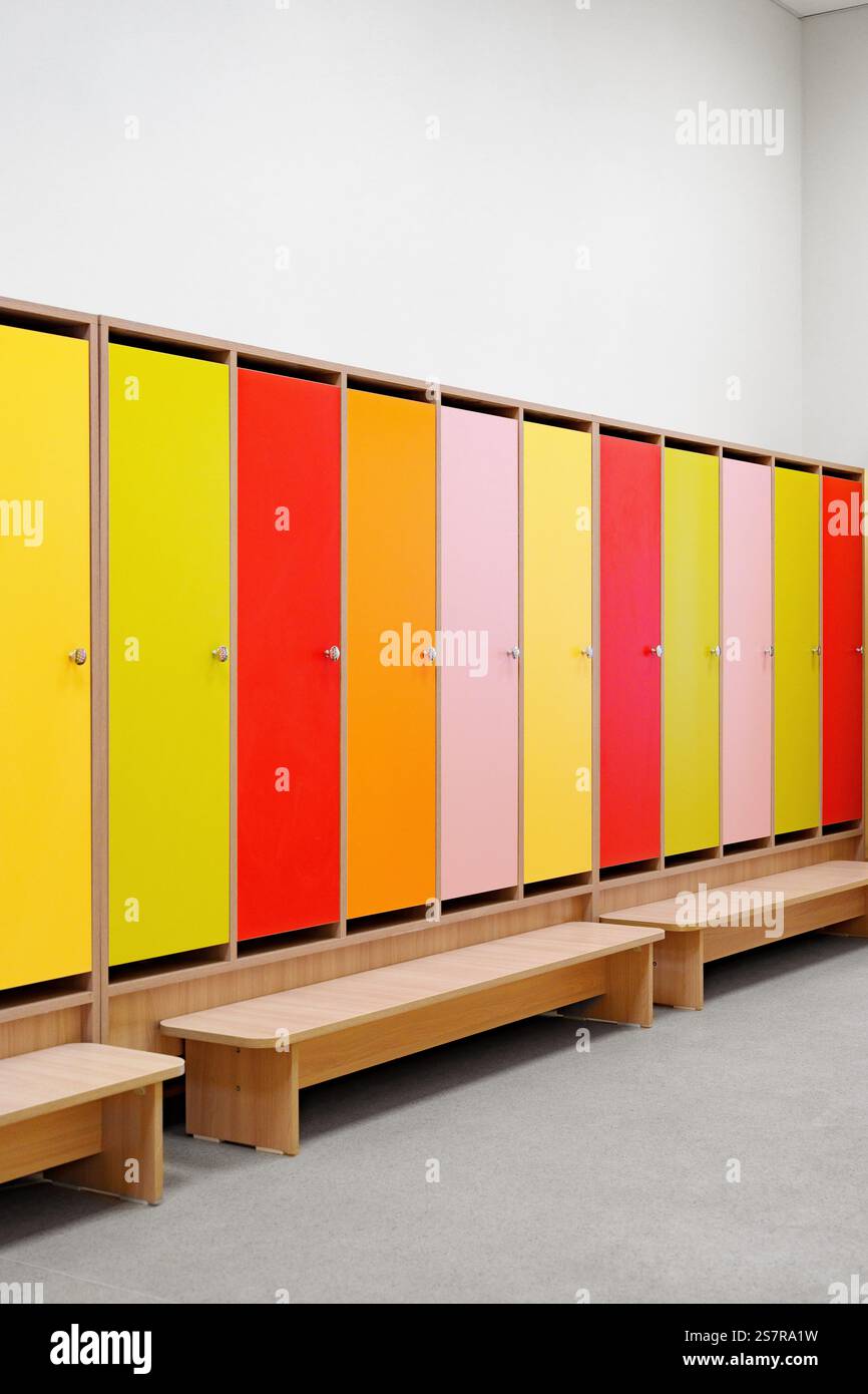 Brightly colored locker doors line a minimalist space designed for ...