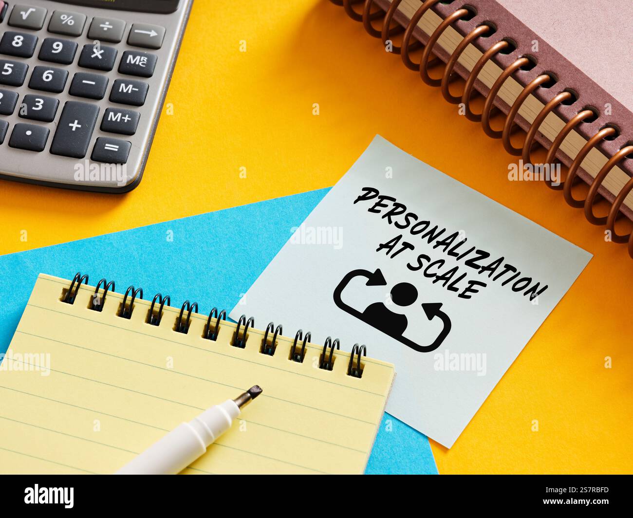Sticky note with personalization at scale concept, calculator, notebook ...