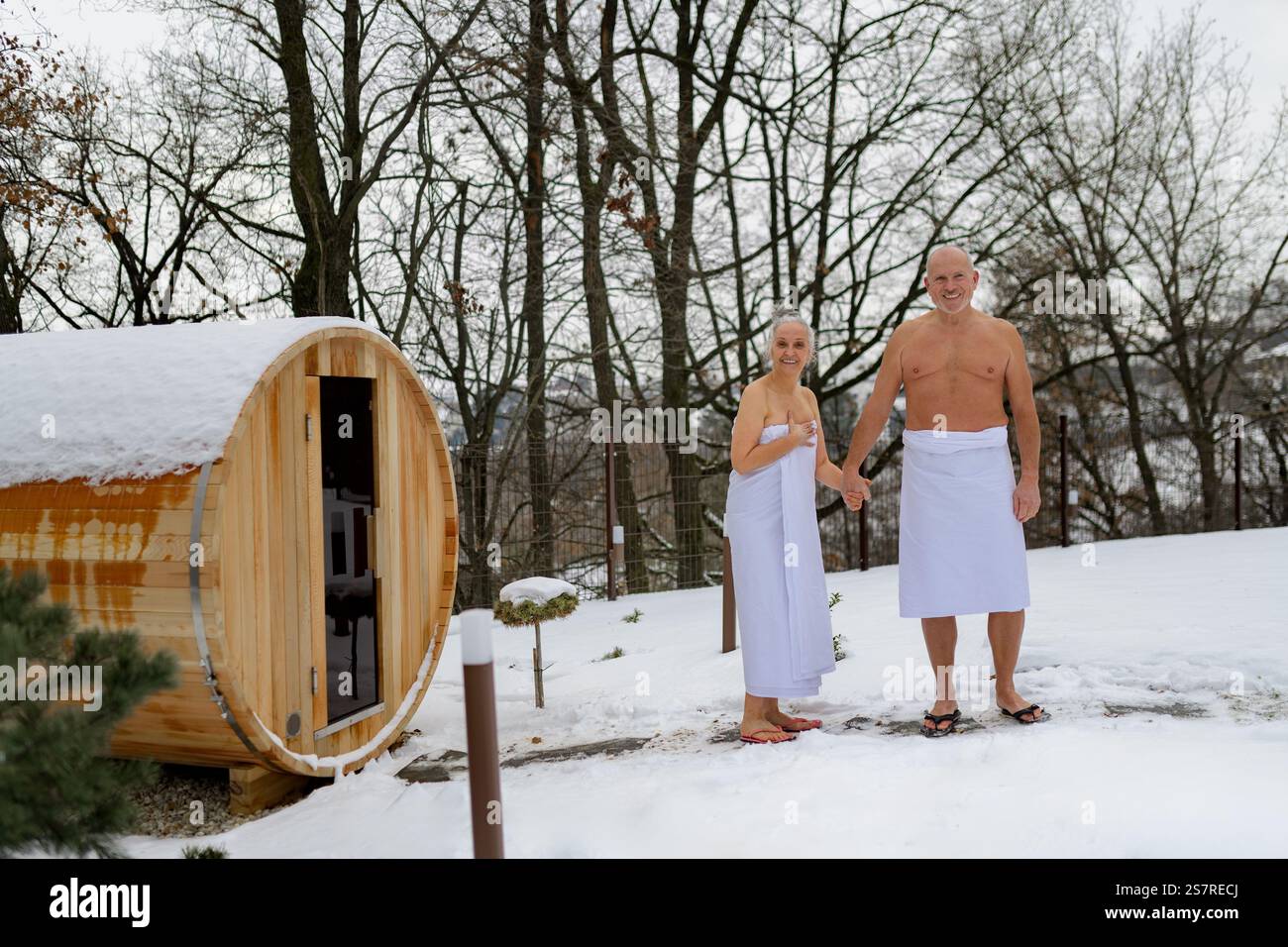 Elderly couple coming out of sauna after a sauna session. Winter spa ...