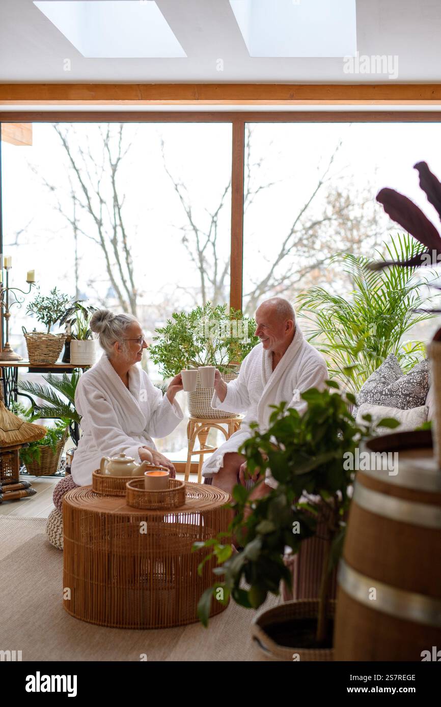 Senior couple, after a spa session, sitting in relaxation room ...