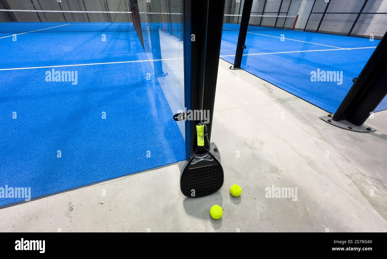 padel racket on a padel court with a ball Stock Photo - Alamy