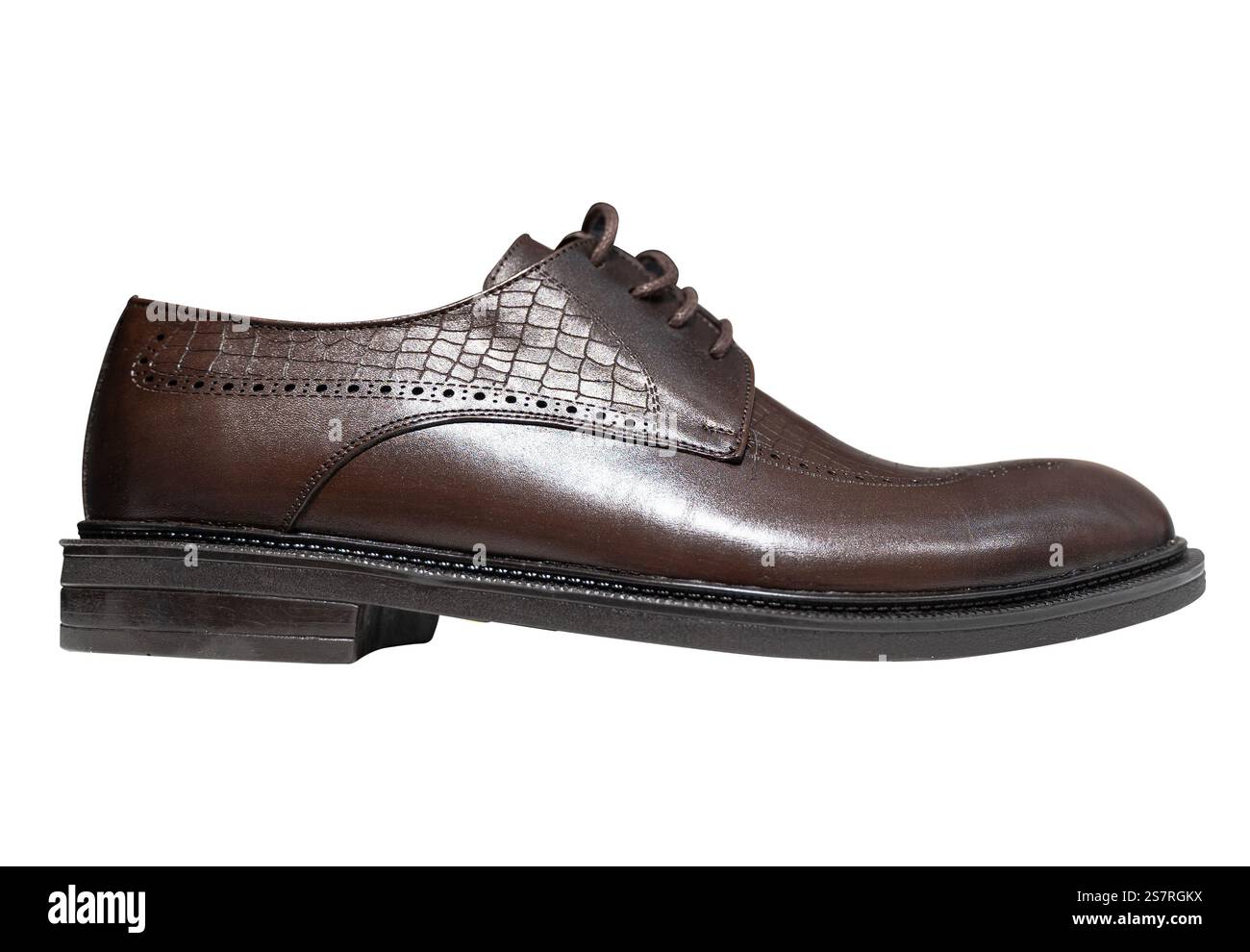 A side view of a classic brown leather oxford shoe with intricate ...