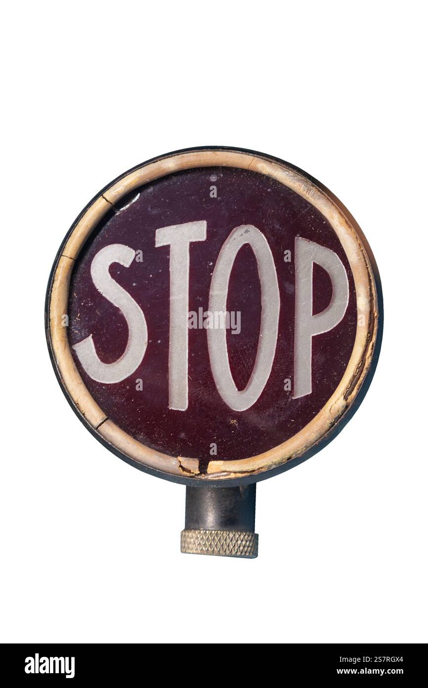 A vintage red stop sign with cracked surface texture isolated on a ...