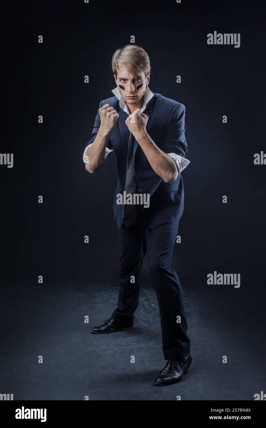 An aggressive businessman with war paint on his face is preparing for ...