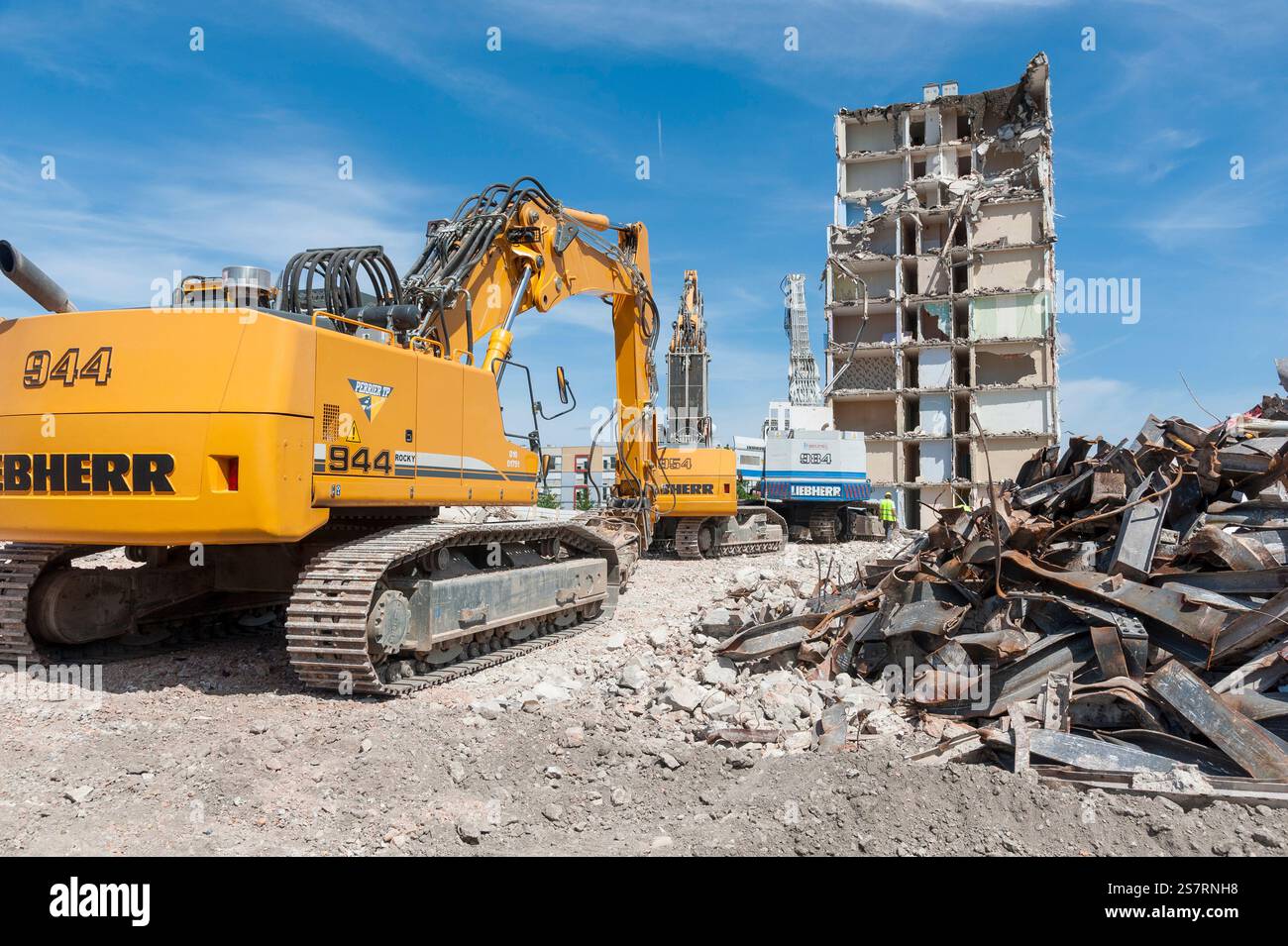 Building deconstruction site. A pile of scrap metal. 3 LIEBHERR ...