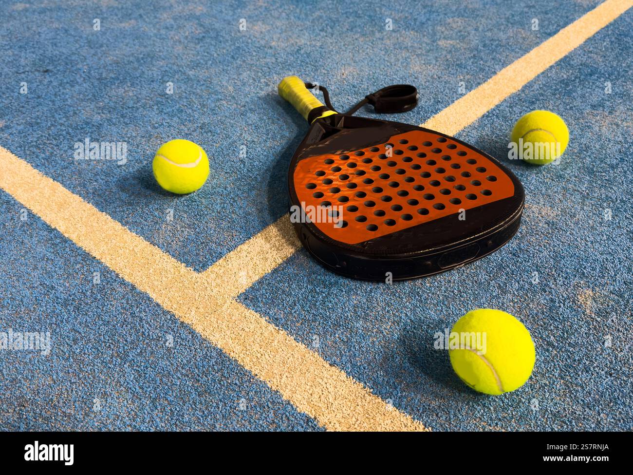 padel racket and yellow balls placed on court near net Stock Photo - Alamy