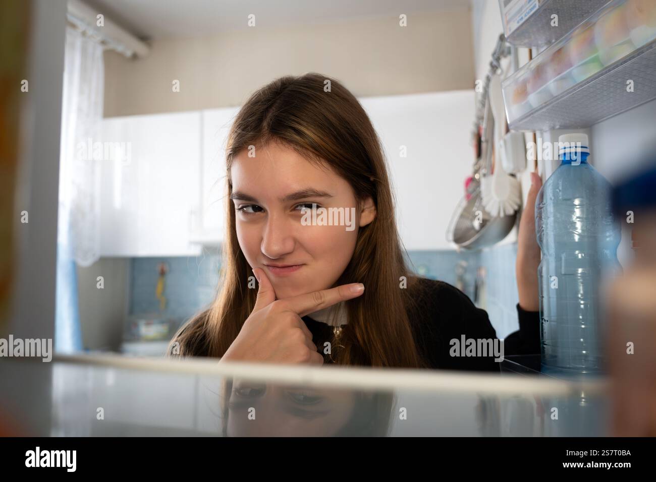 hungry girl open empty refrigerator point of view from inside fridge. A ...