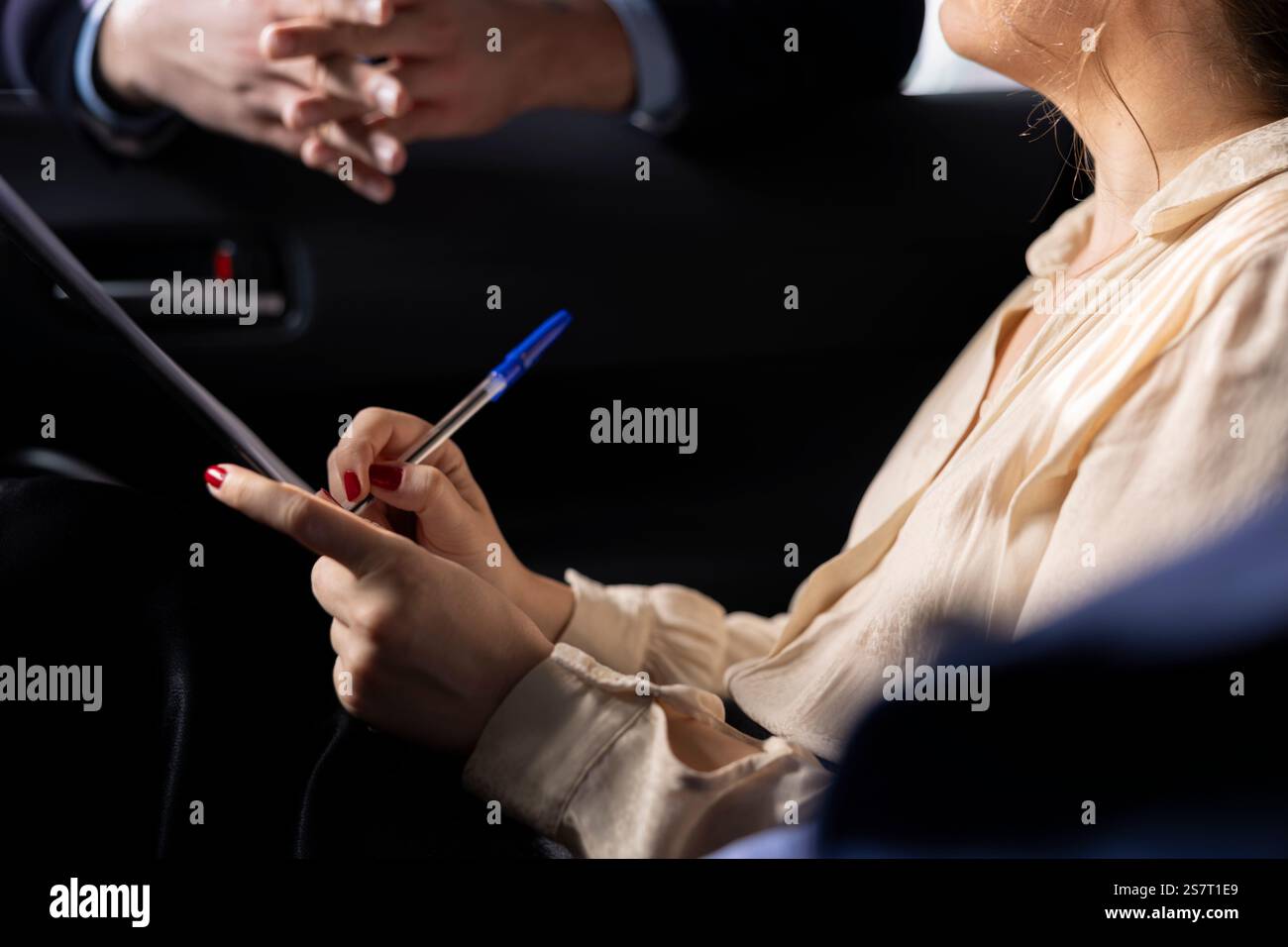 Woman signing deal contract after finishing test drive in car ...