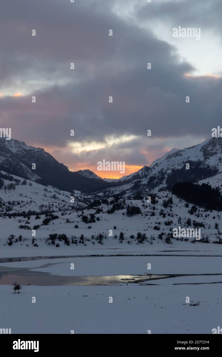 Breathtaking winter sunset with vibrant colors illuminating the snowy ...