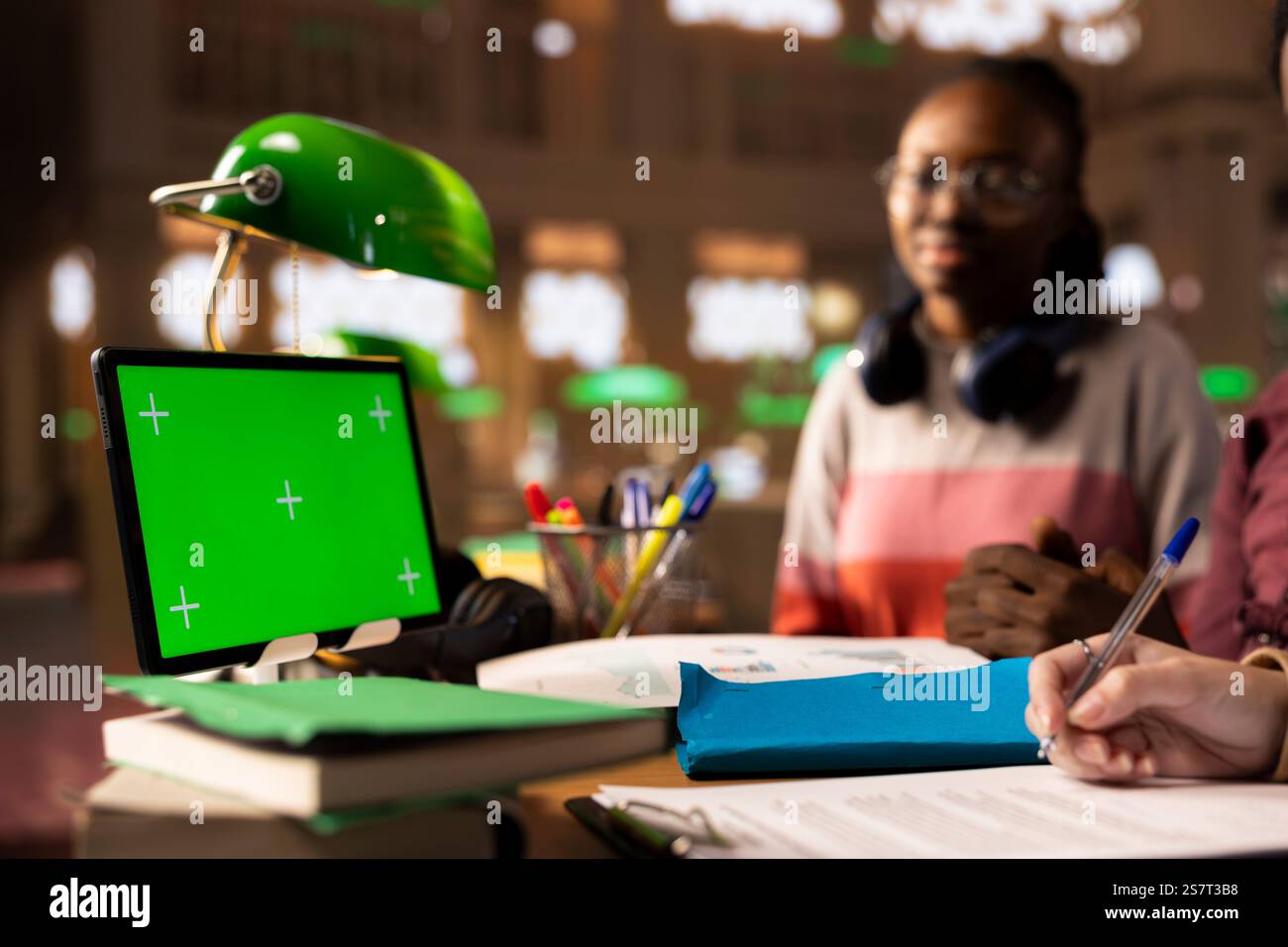 Young student working with a green screen in the university campus ...