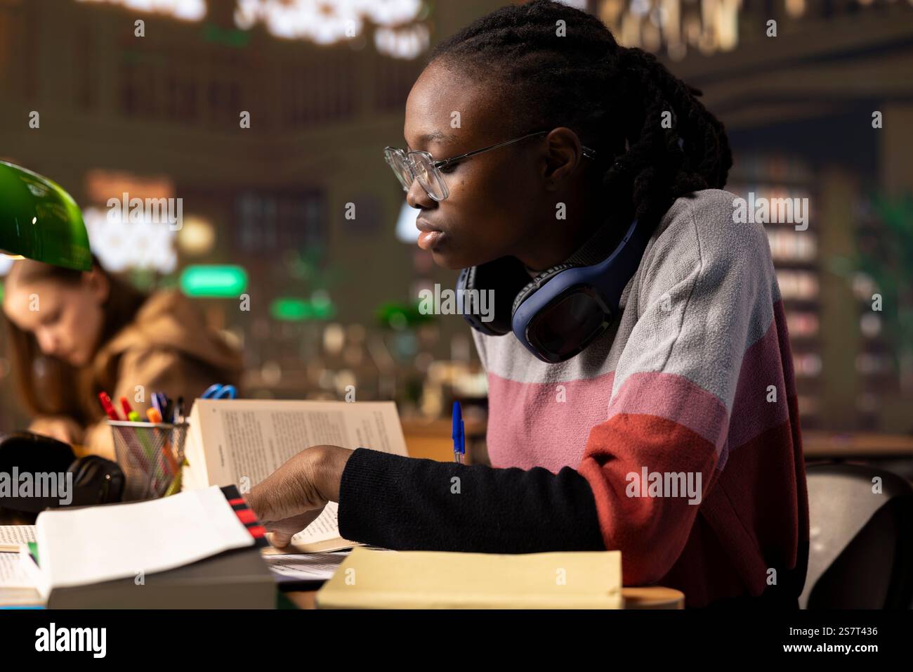 African american college student writes her bachelor degree paper ...