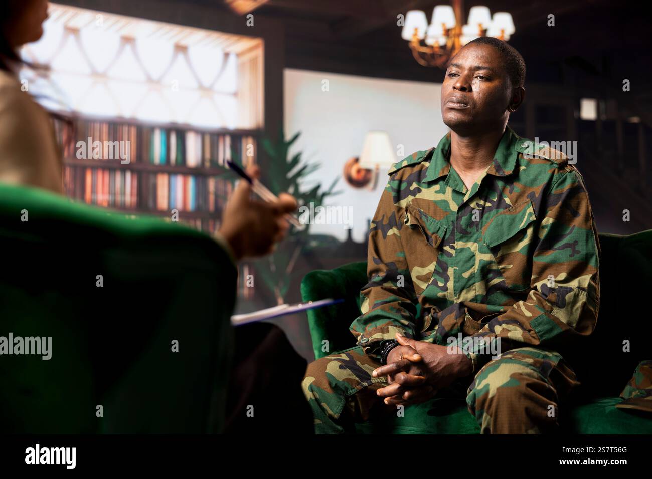 Female psychologist assists a black soldier in a counseling session ...