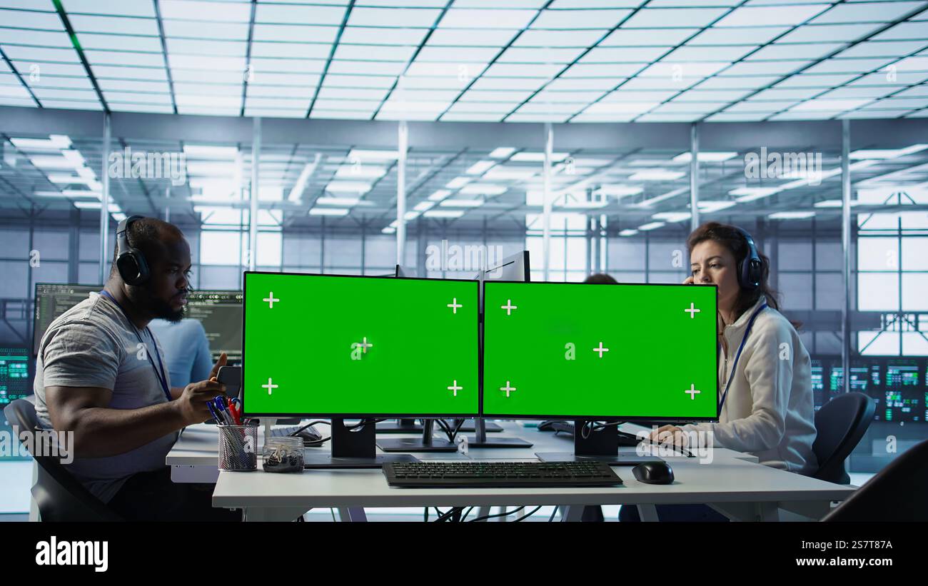 Close up of multi monitor isolated screen computer in data center used for supervising server ...