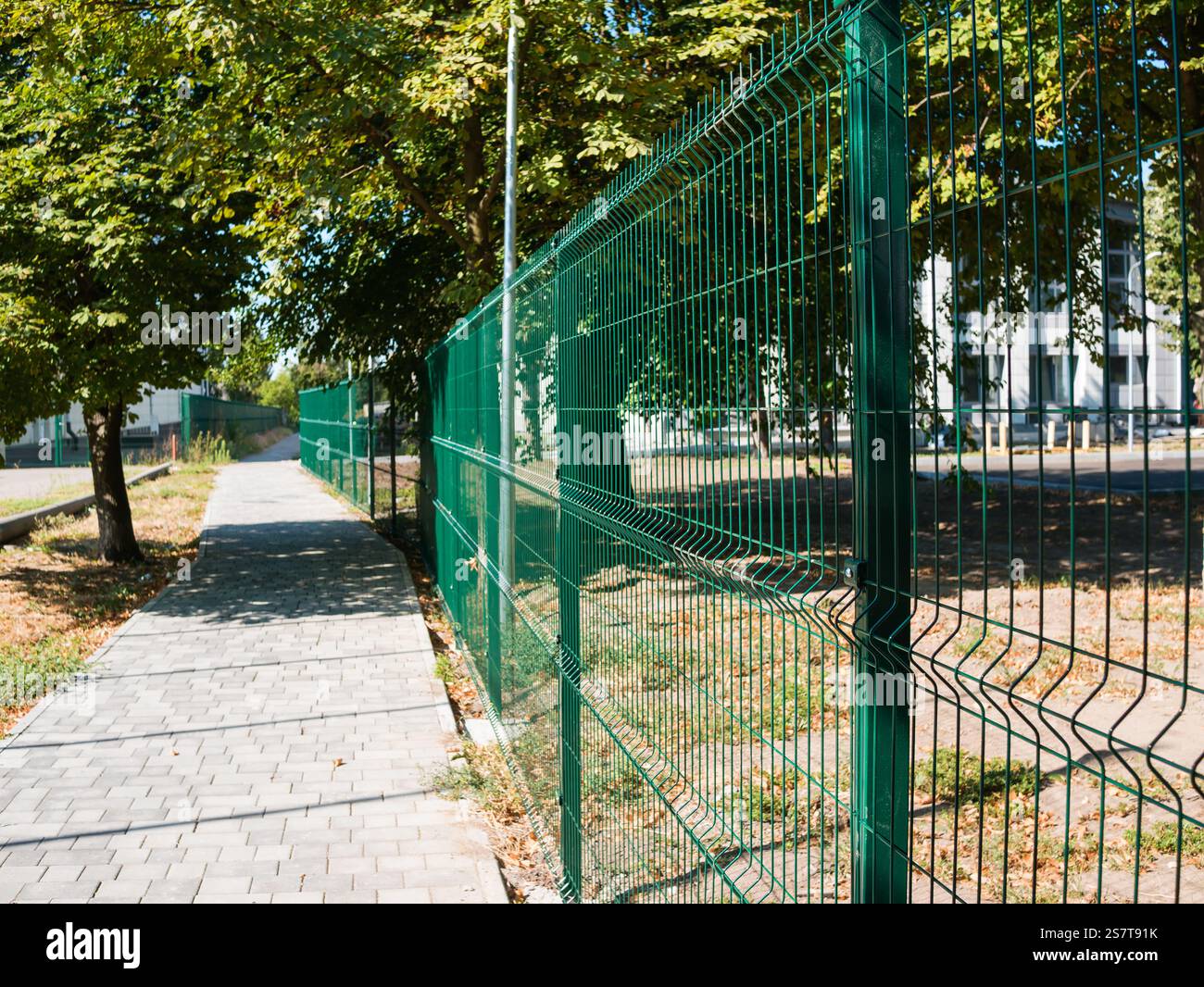 Metal fence made of mesh with rectangular cells Stock Photo - Alamy