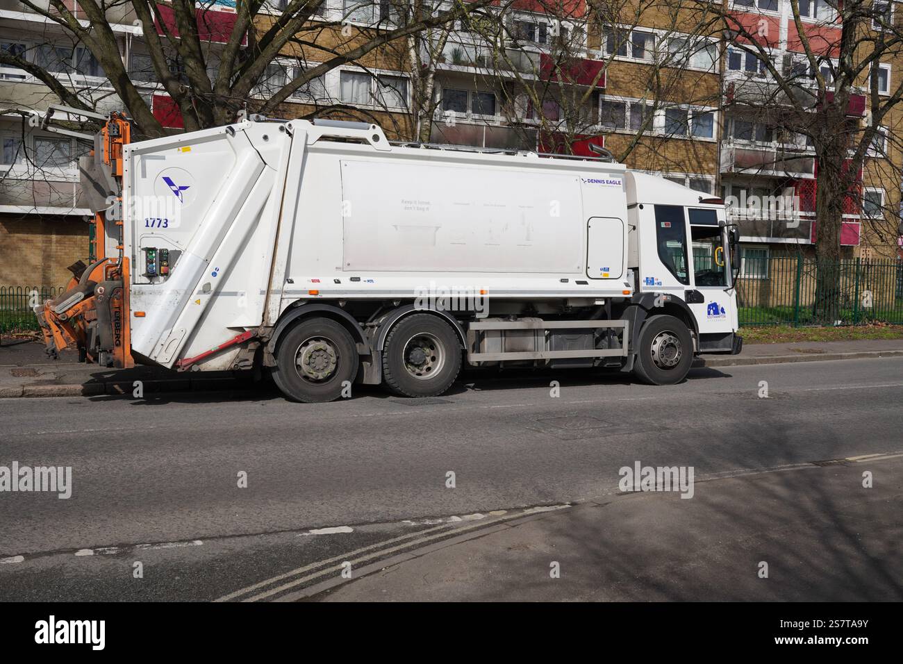 A waste collection vehicle on bin day in UK city. Council service bin ...
