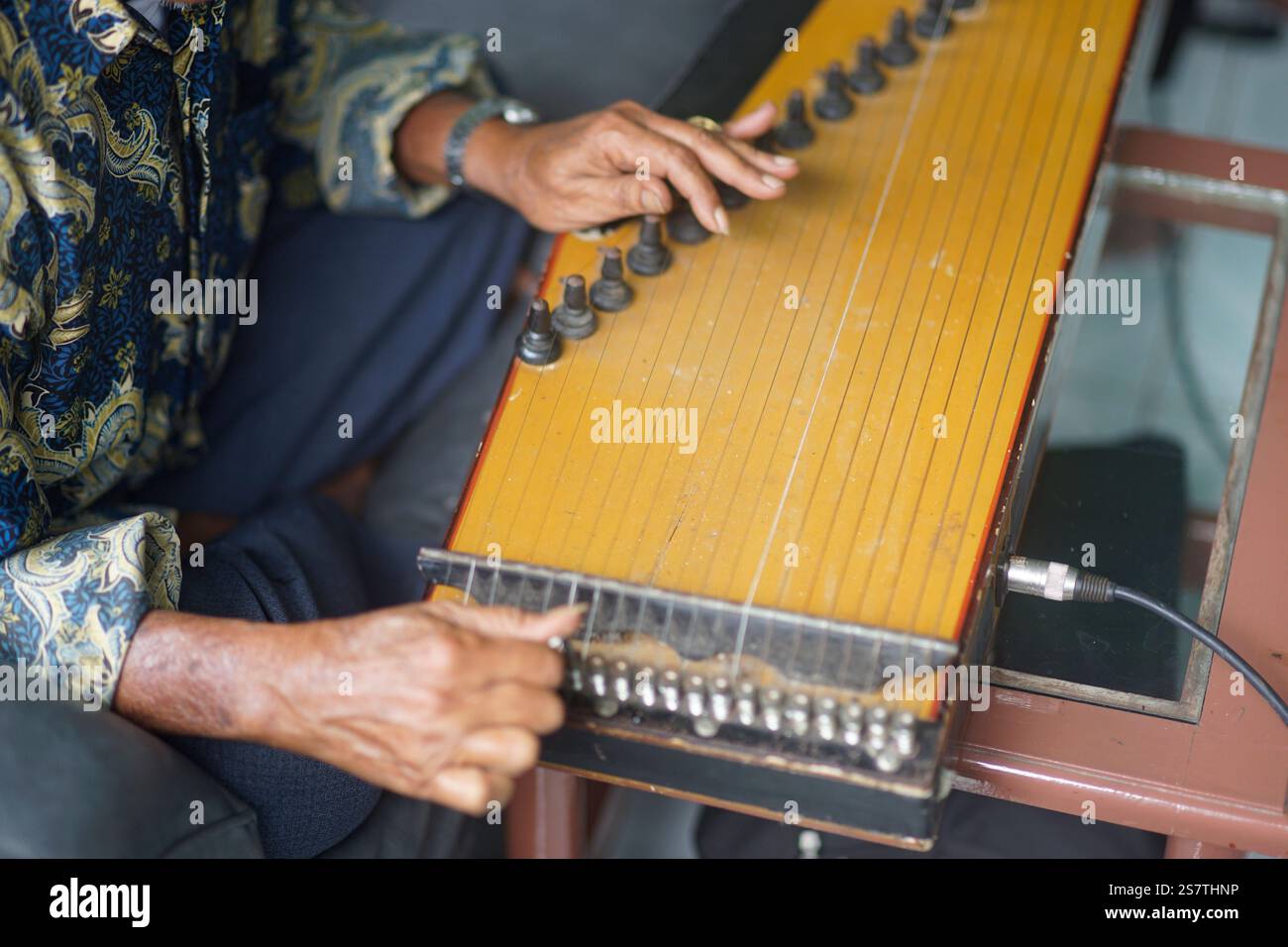 parents are tuning kecapi. original Indonesian musical instruments ...