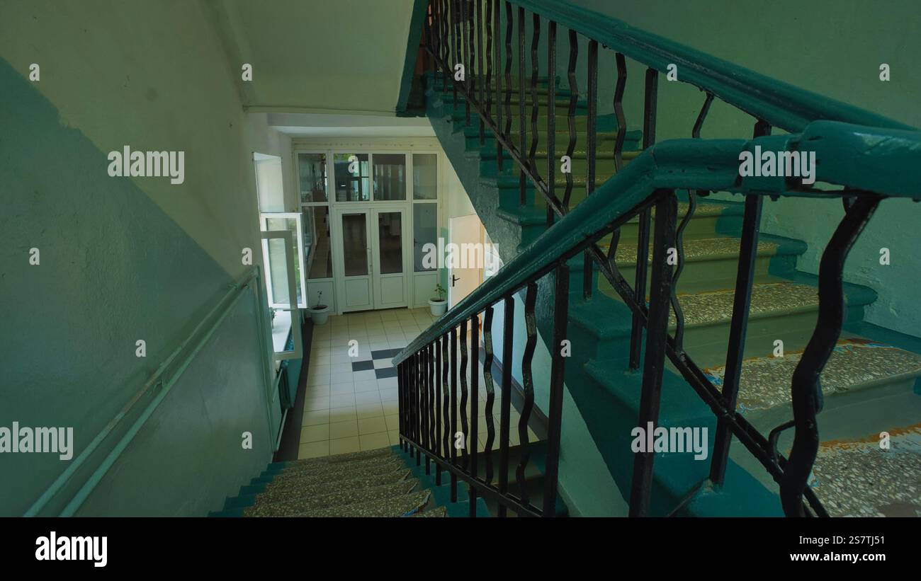 School's last day, empty staircase with green railing leading to ...