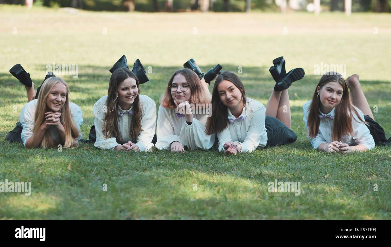 School girls lying on grass hi-res stock photography and images - Alamy