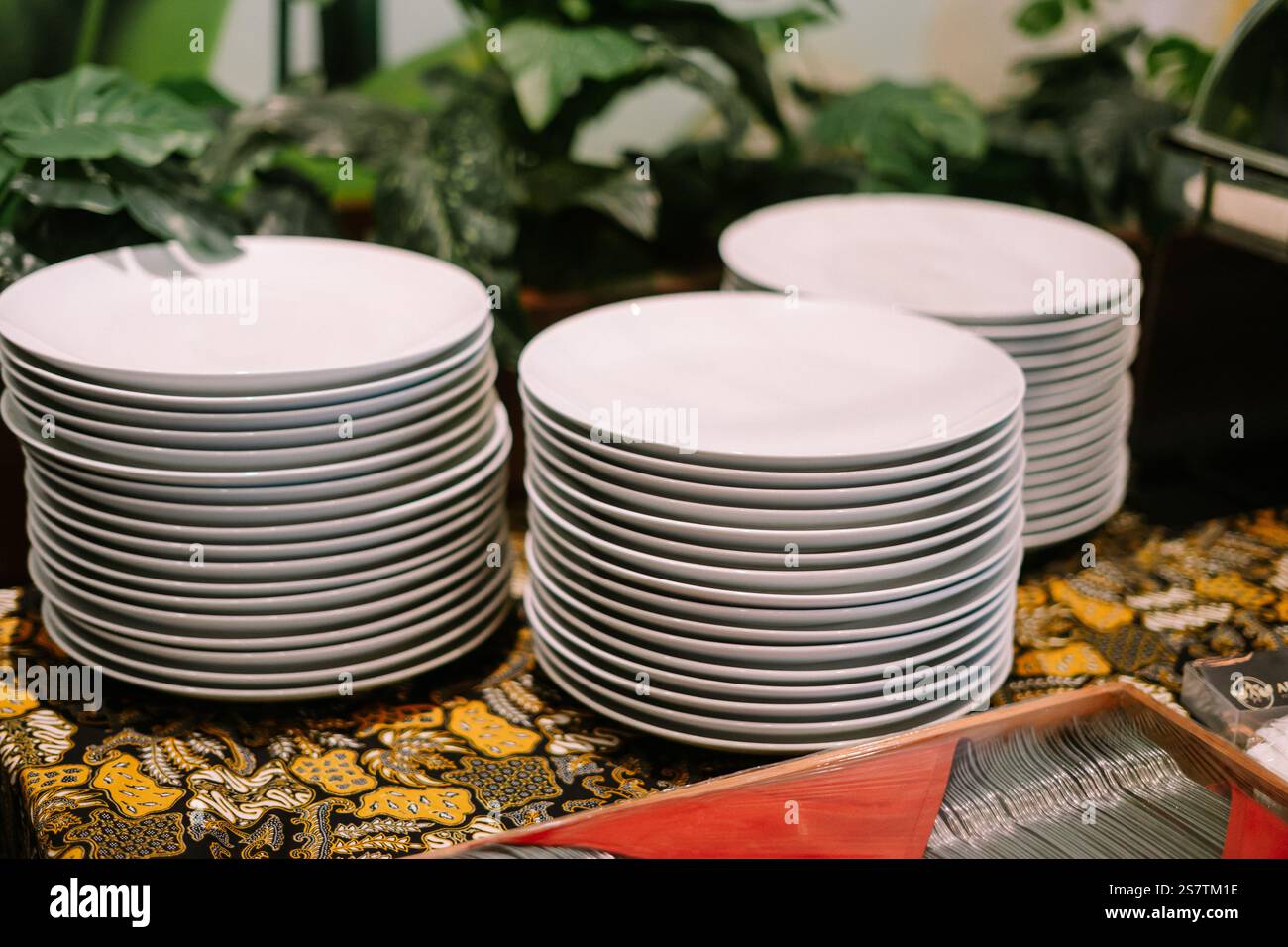 Stacks of clean white plates ready for a catered event Stock Photo - Alamy
