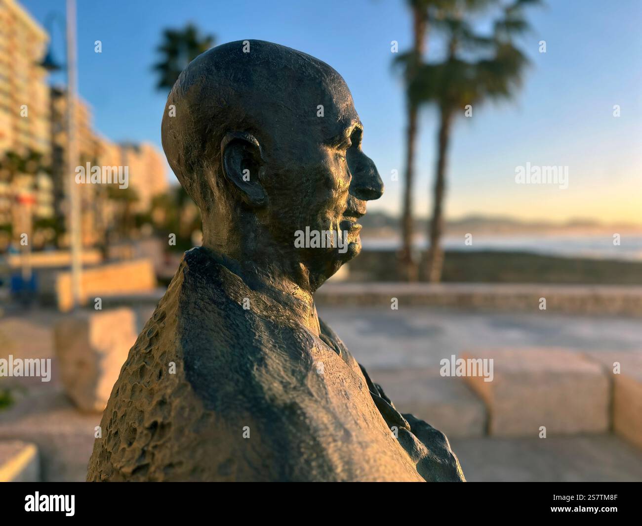 Side view of statue of old man along the beach Stock Photo - Alamy
