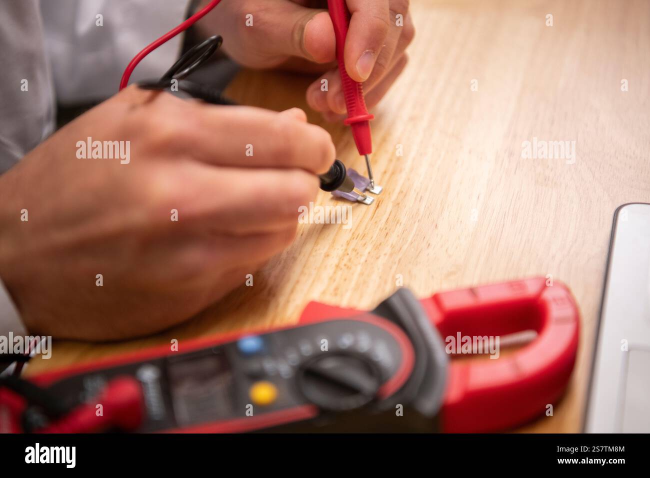 testing a small fuse for resistance using a multimeter Stock Photo - Alamy