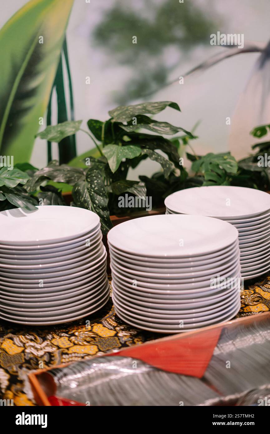 Stacks of clean white plates ready for a catered event Stock Photo - Alamy