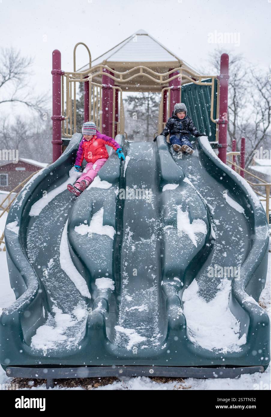 Children Sliding Down a Snow-Covered Slide Stock Photo - Alamy