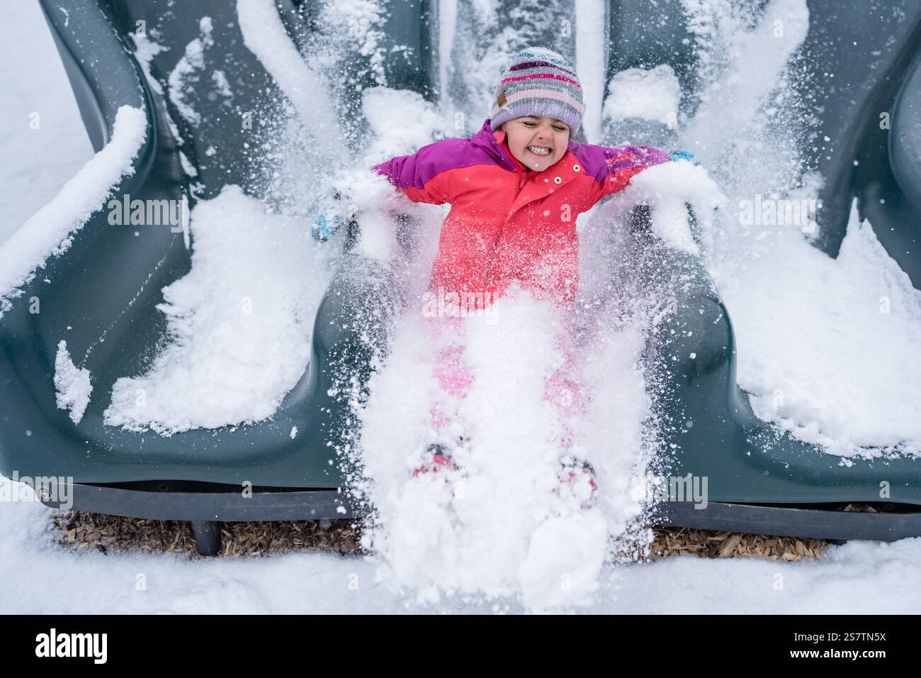 Child Sliding Down a Snow-Covered Slide Stock Photo - Alamy