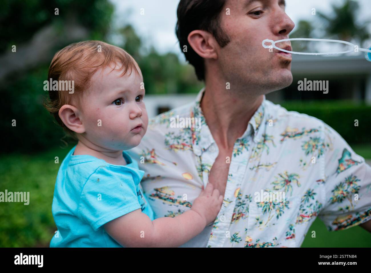 Dad and Daughter Blowing Bubbles Stock Photo - Alamy