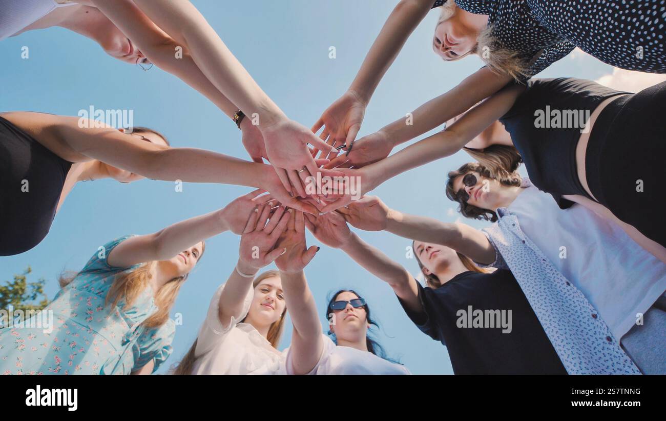 High school students come together in a circle, showing unity, teamwork ...