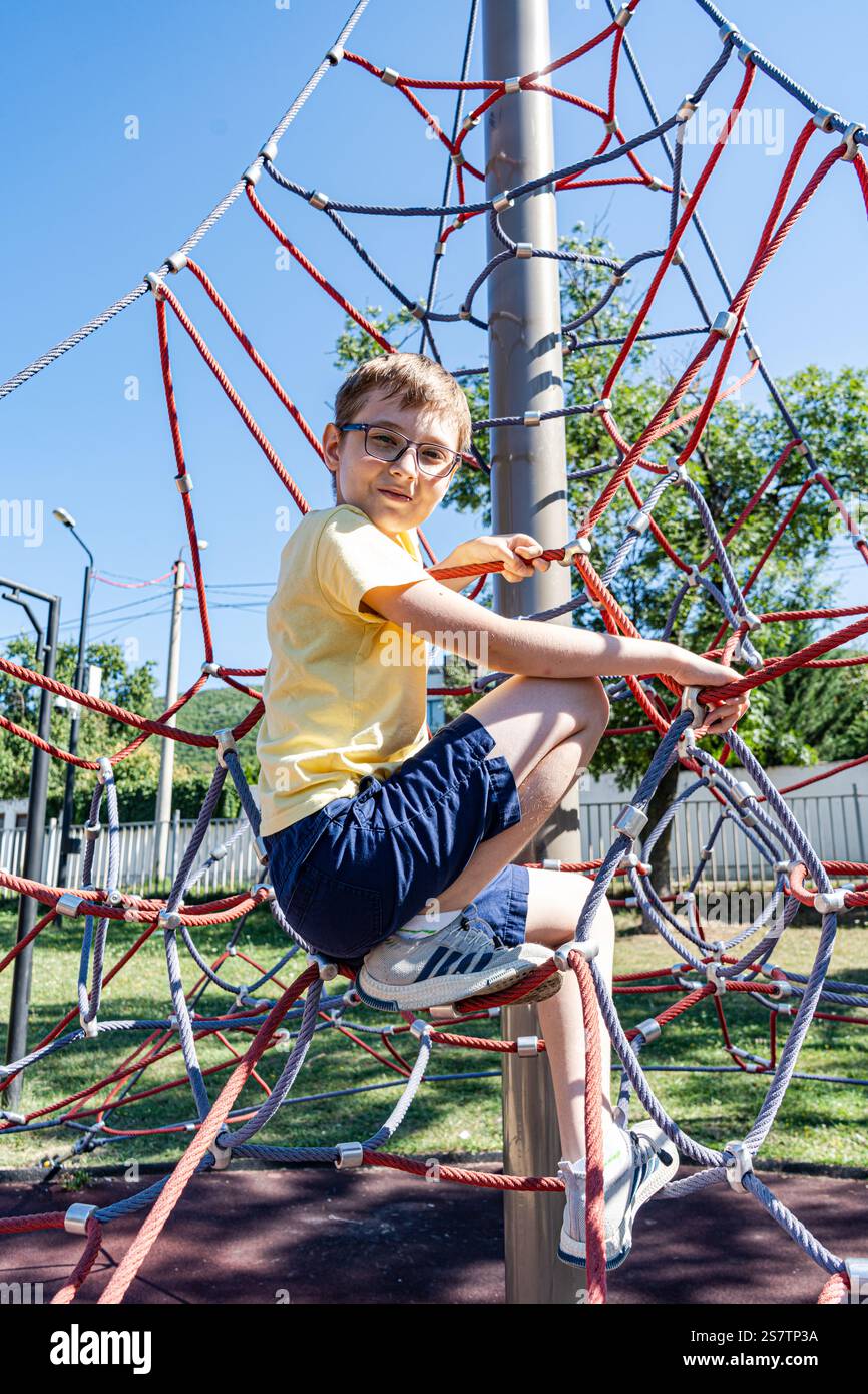 Teenager boy playing on the rope playground Stock Photo - Alamy