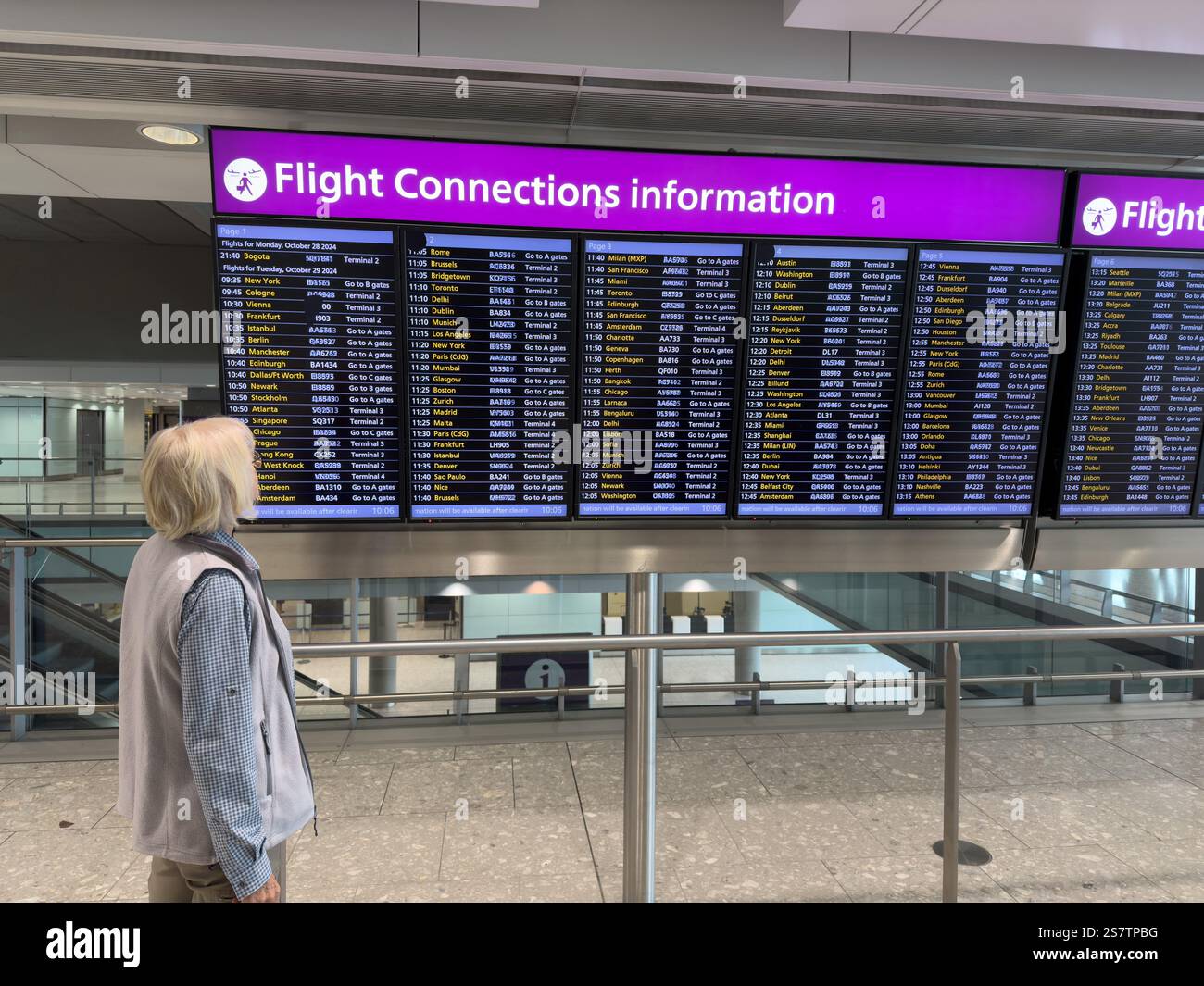 A traveler looks at the flight connections information screen at ...