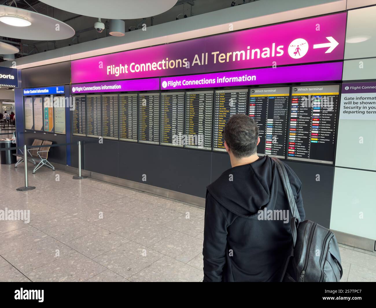 A traveler looks at the flight connections information screen at ...