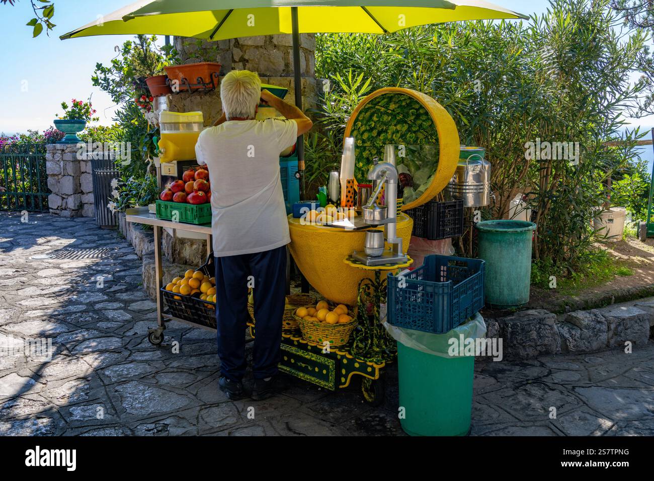 A vendor makes fresh fruit juice drinks at a stand by the Amalfi Coast ...