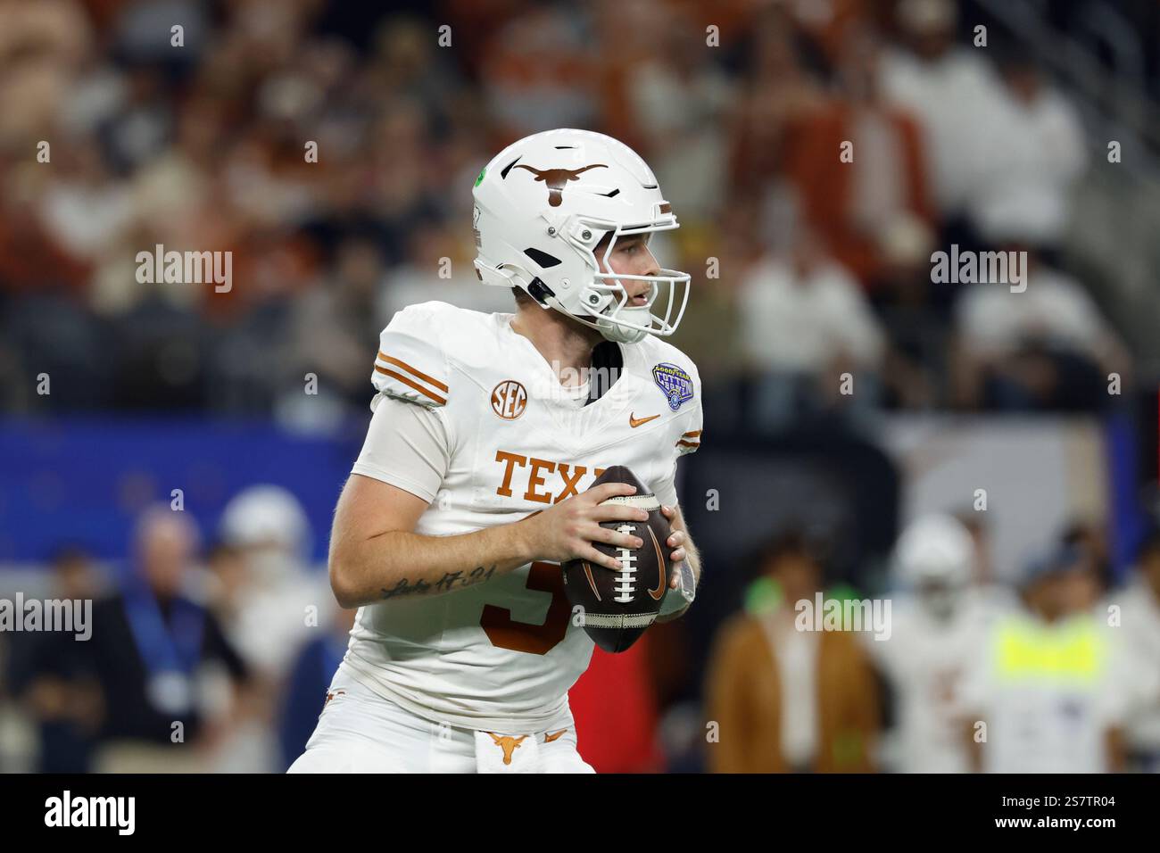 Texas quarterback Quinn Ewers (3) looks to pass during the NCAA CFP semi final Cotton Bowl ...