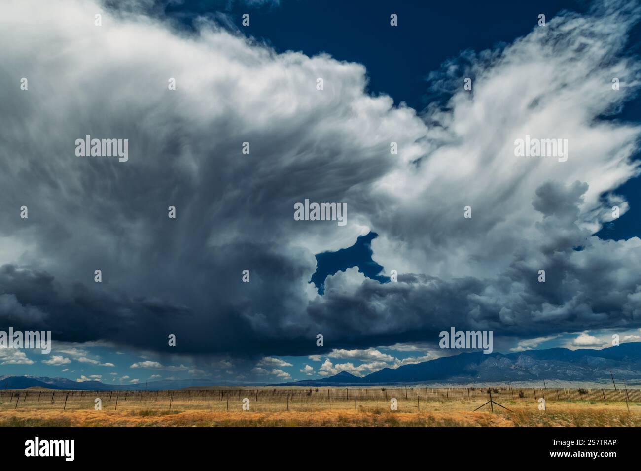 Large Storm cloud building over mountain range with rain falling Stock ...