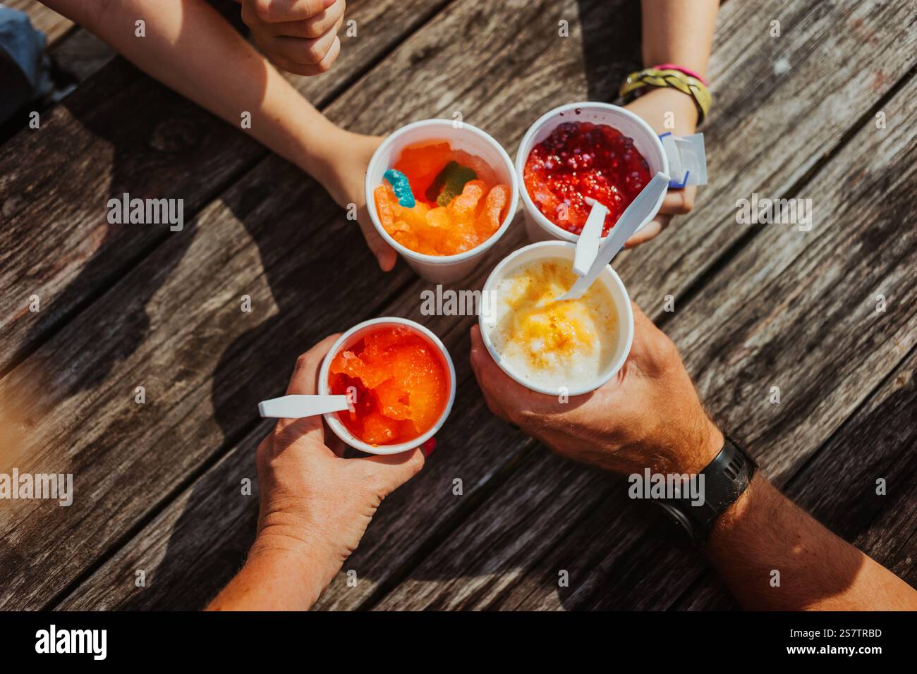 Group of people holding colorful snow cones Stock Photo - Alamy
