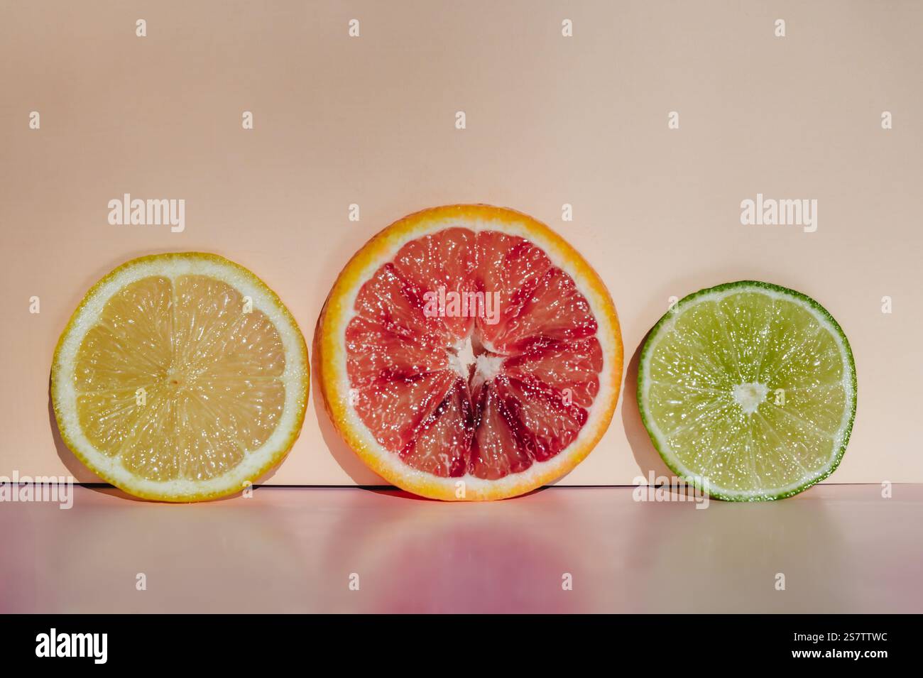 Sliced lemon, blood orange, and limes sparkling in light Stock Photo ...