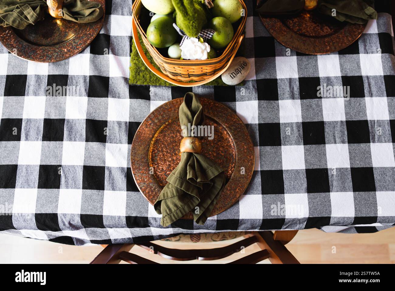 Rustic dining setup with copper plate, napkin, and gingham tablecloth ...