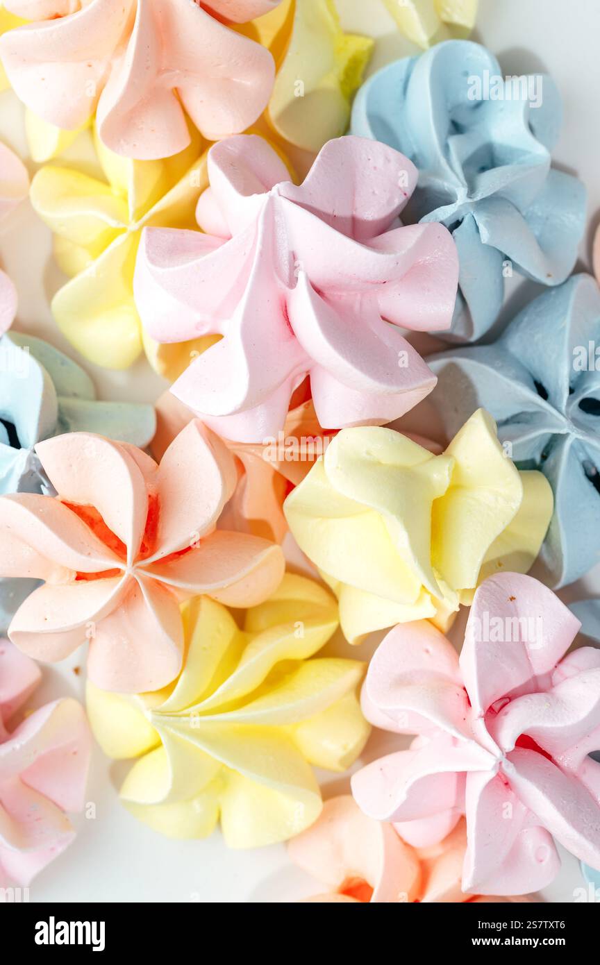 multi-colored meringues on a white background Stock Photo - Alamy