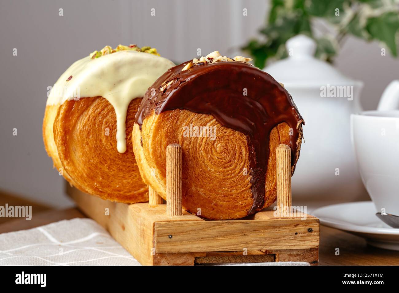 round croissant with icing on a stand Stock Photo - Alamy
