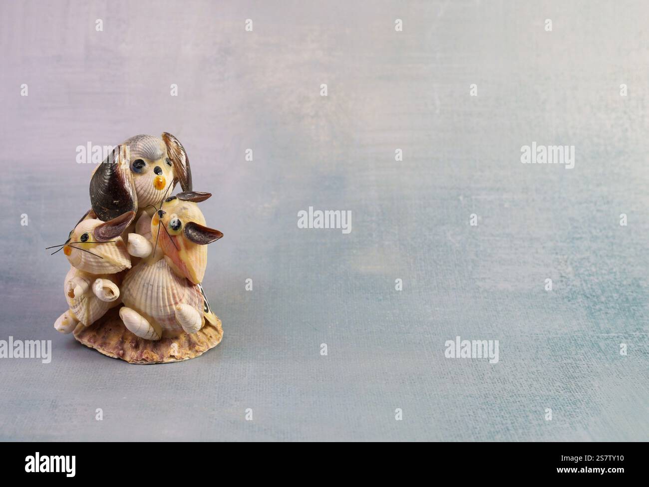 Shell Dog Statue with Two Kittens on a Light Gray Background Stock ...