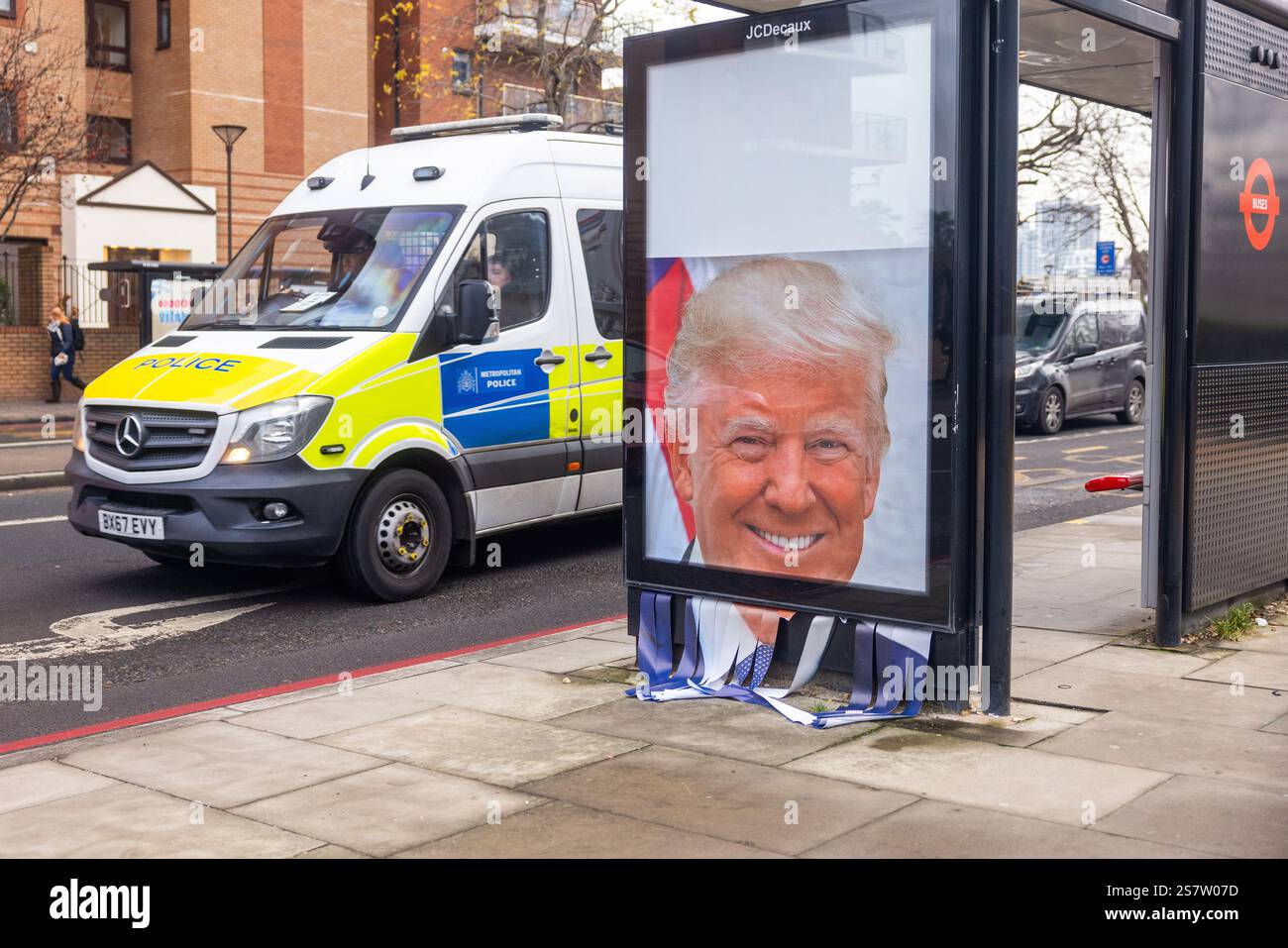 London, UK. 20 JAN, 2025 Shredded sign of the president elects face on ...