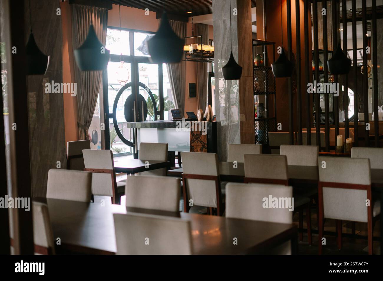 Stylish restaurant interior with rows of tables and chairs, ready for ...