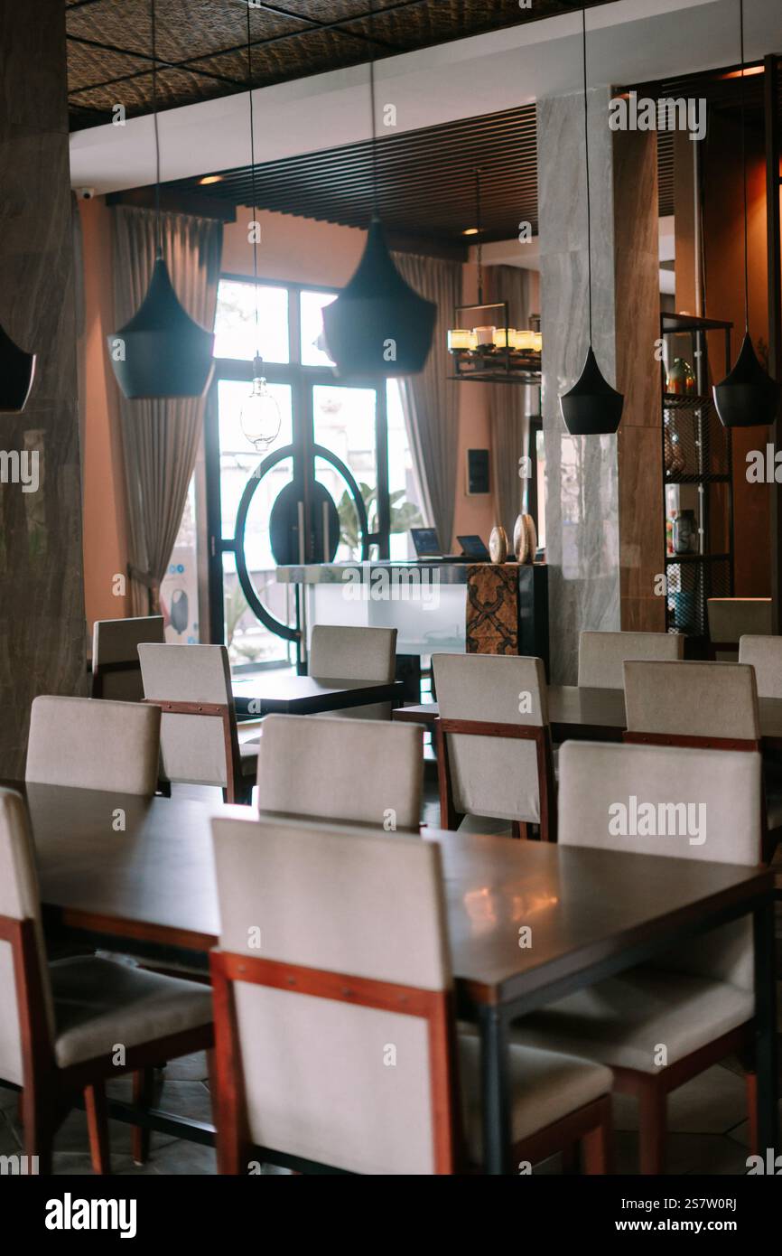 Stylish restaurant interior with rows of tables and chairs, ready for ...
