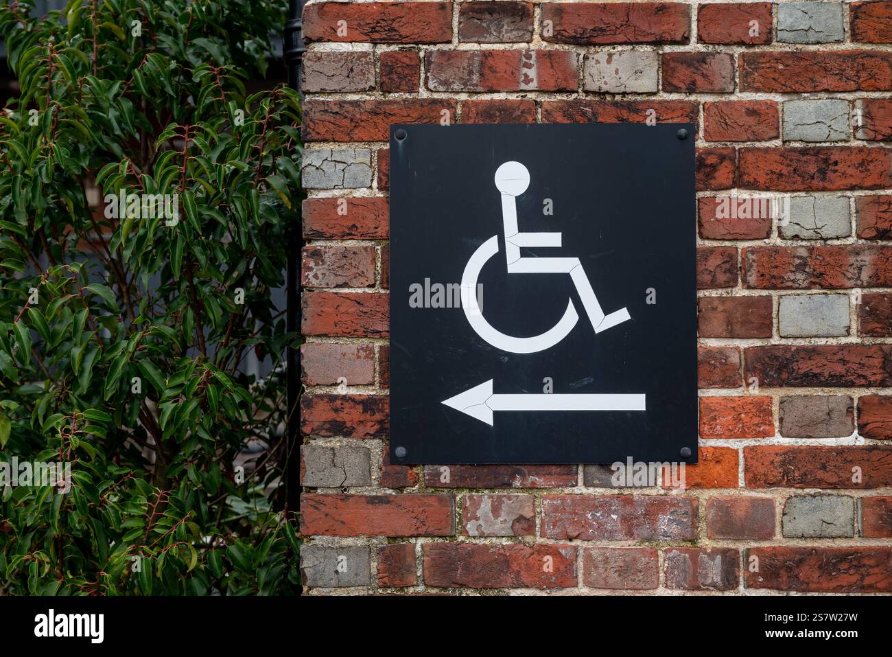 Accessibility sign in black and white on a brick walk showing easy ...