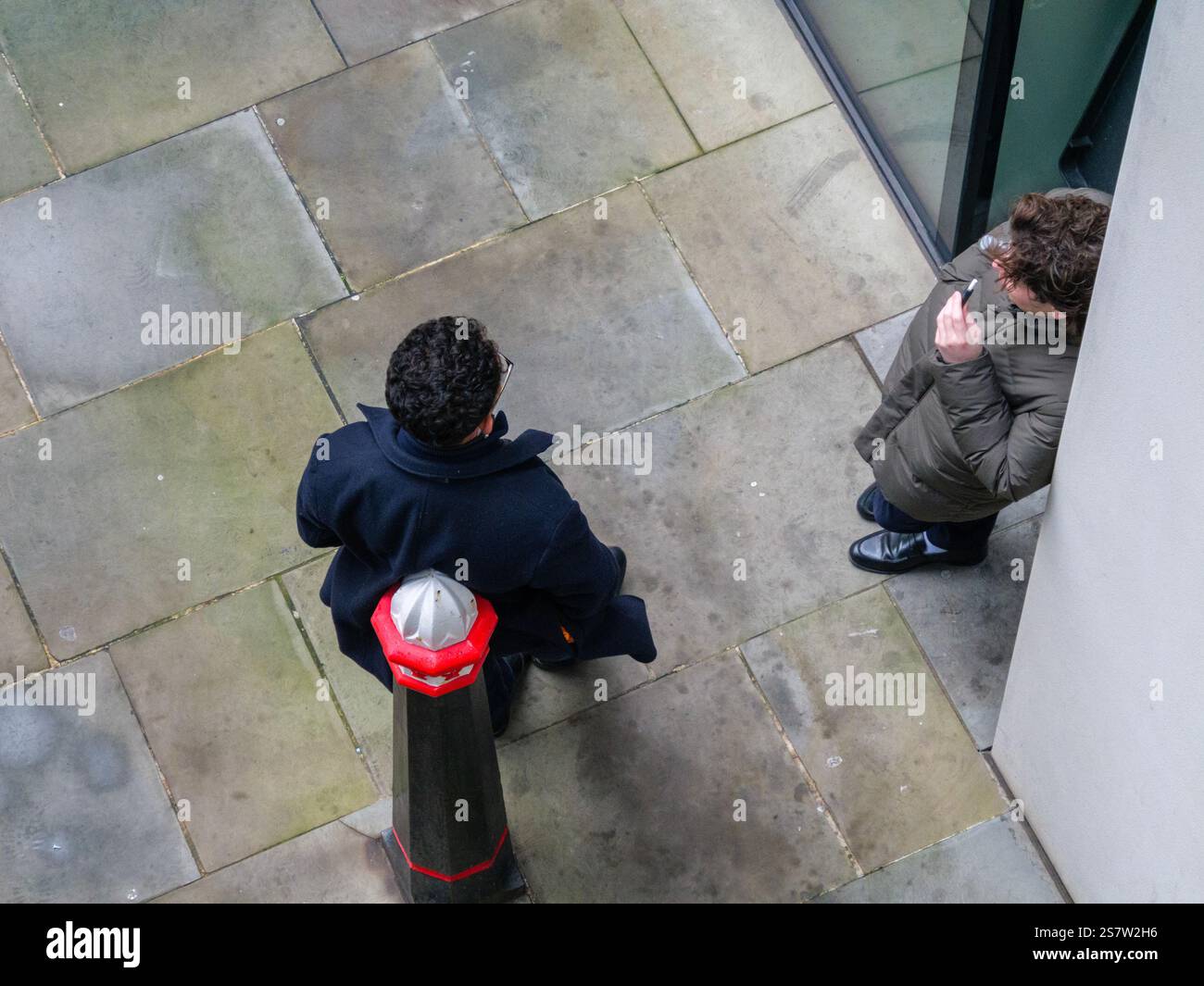 aerial view of Smokers outside their office building taking a smoking ...
