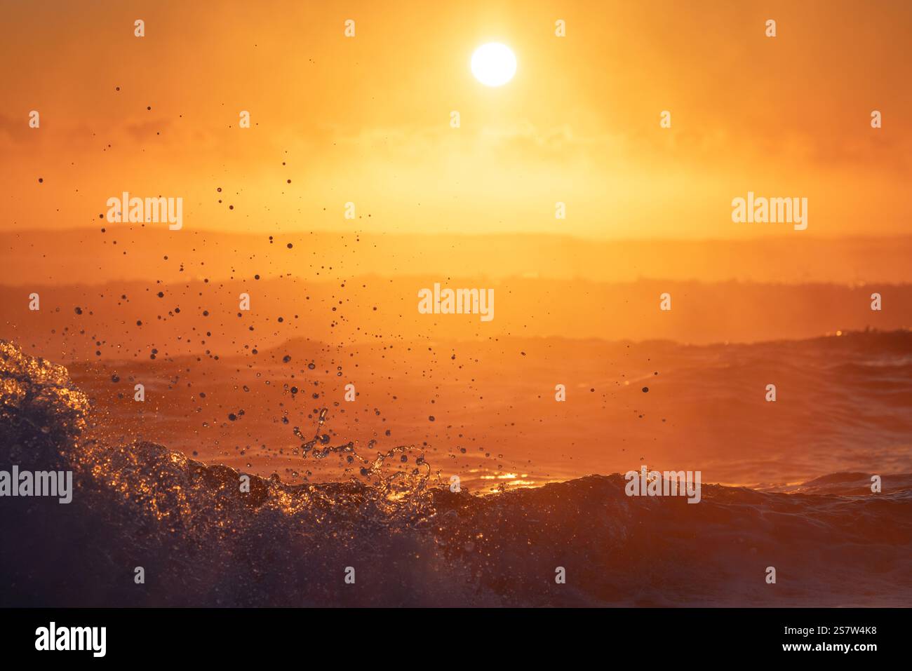 Golden Sunset Over Ocean Waves With Splashes and Mist Stock Photo - Alamy