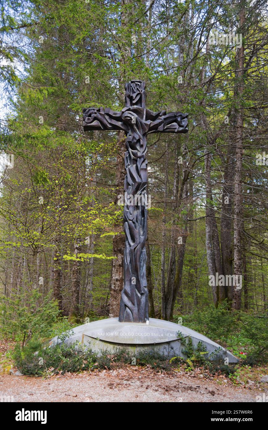 Wooden cross in a forest, surrounded by trees, symbolising Christian ...
